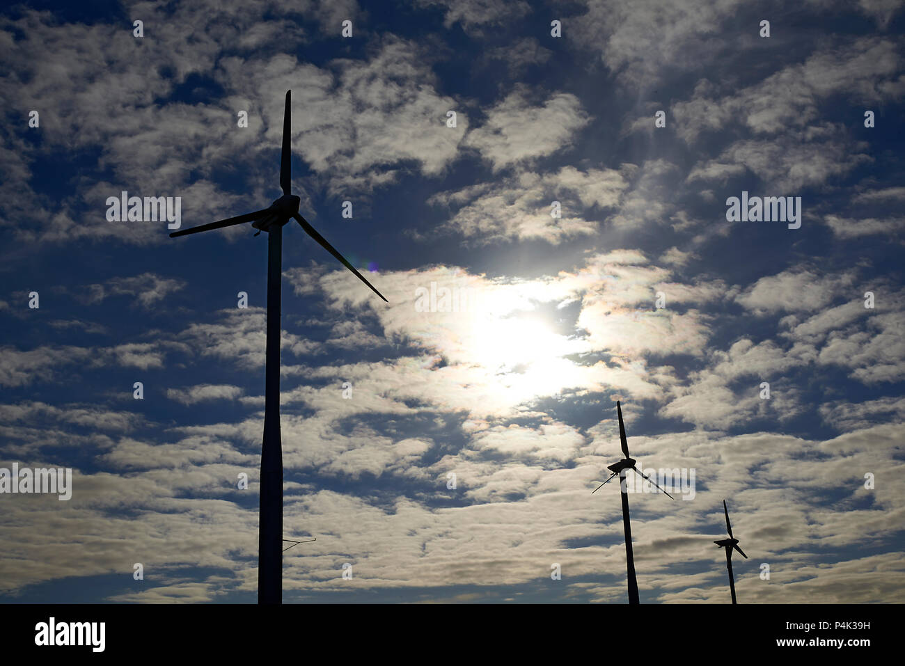 Dynamic low angle close up shot of a modern wind turbine park ...