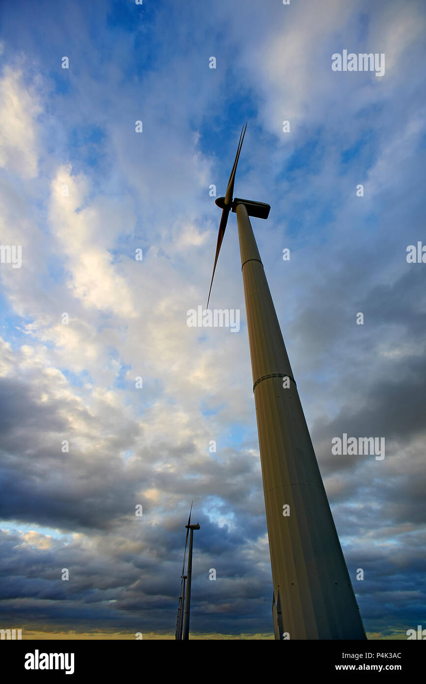 Dynamic low angle close up shot of a modern wind turbine park ...