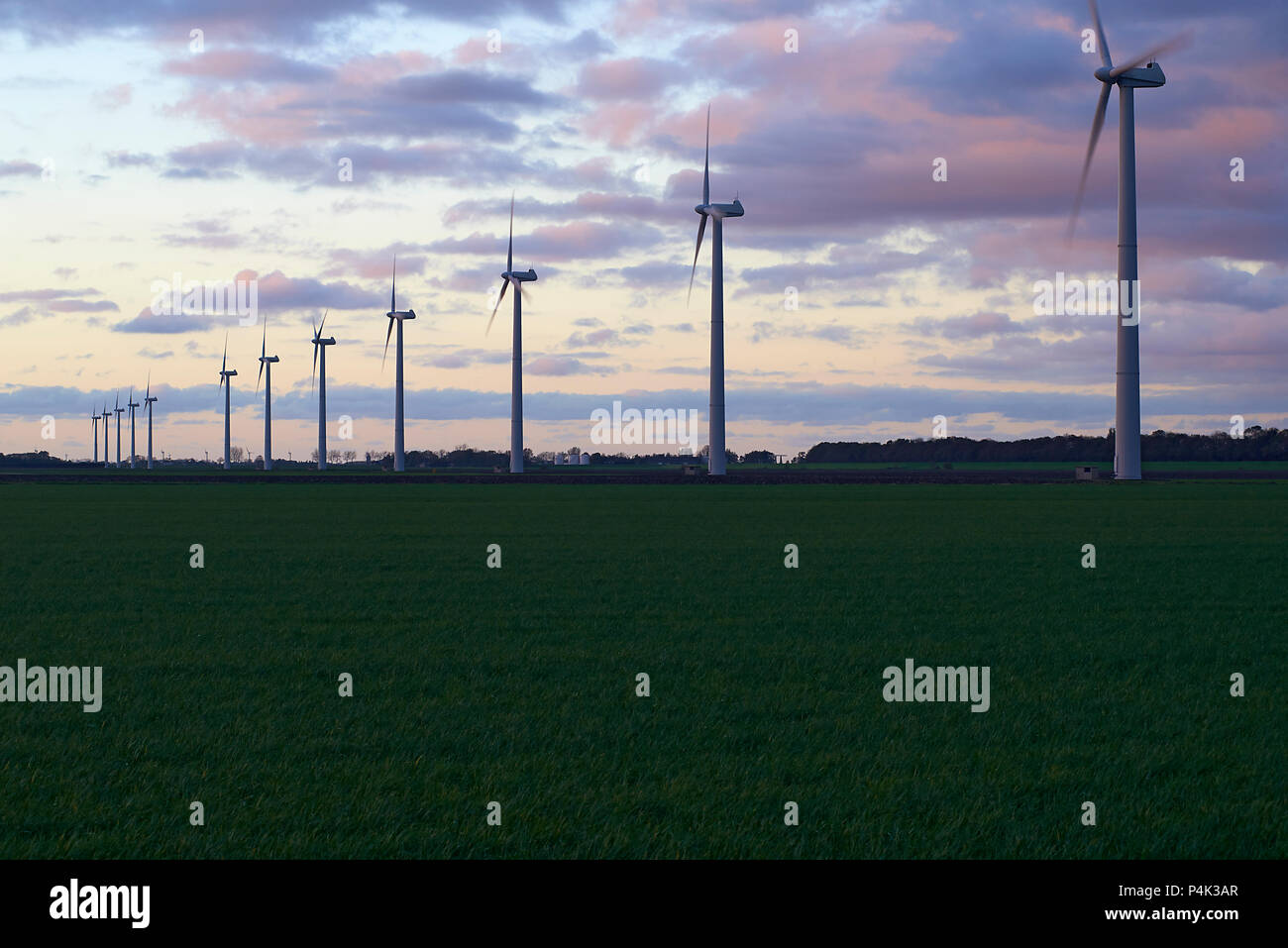 Stunning landscape of a huge windpark with wind turbines lining up in a ...