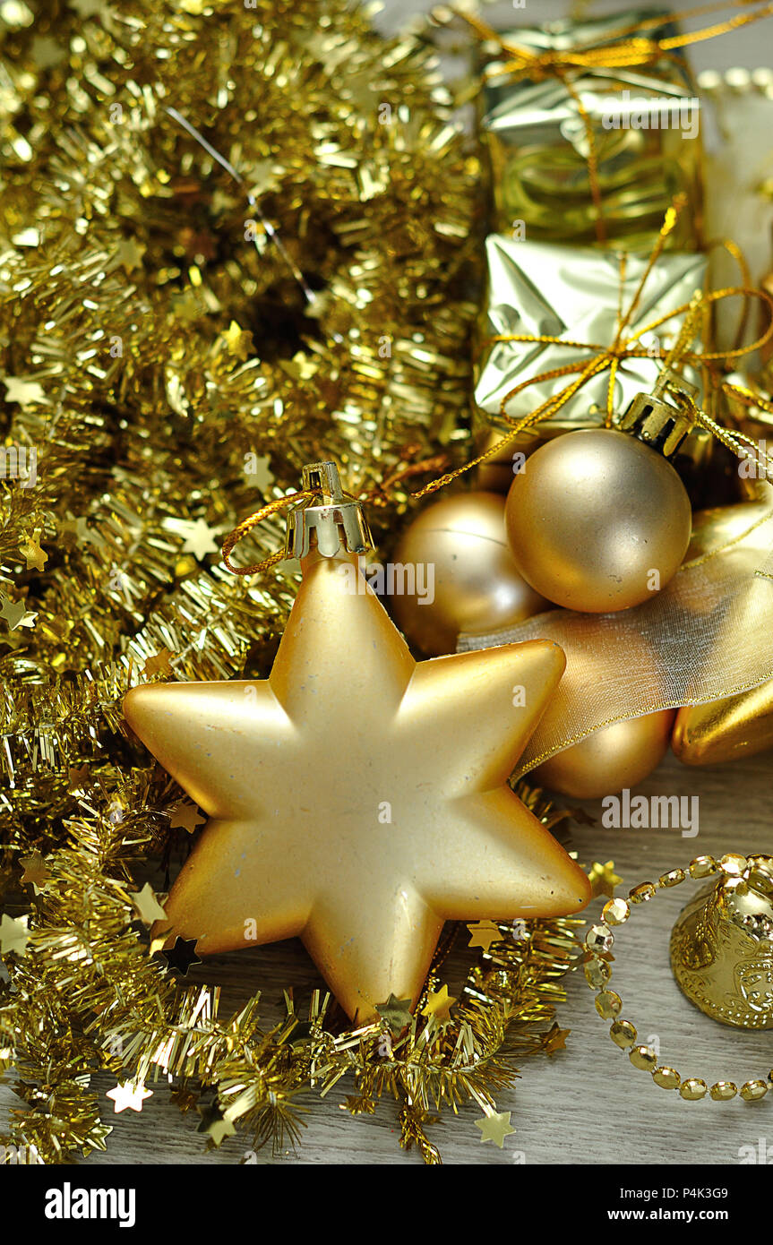 A variety of golden christmas tree decorations displayed with golden ...