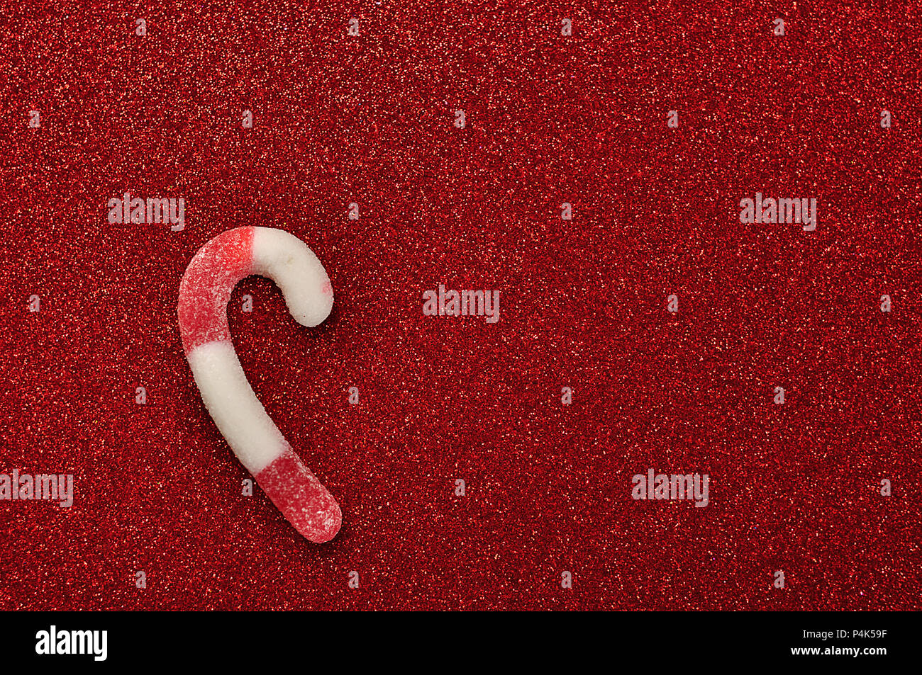 A red and white stripe candy cane in a red background Stock Photo - Alamy