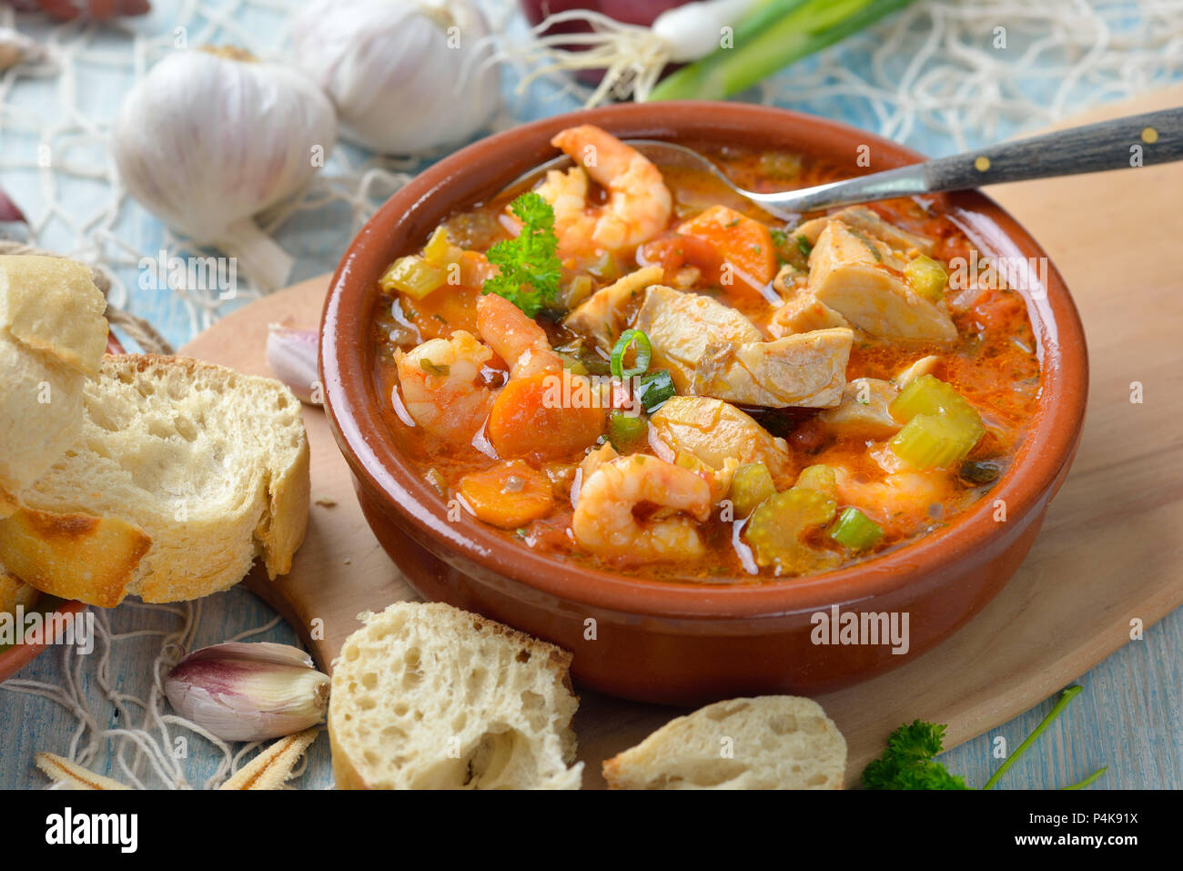 Mediterranean fish soup served with fresh white bread Stock Photo - Alamy