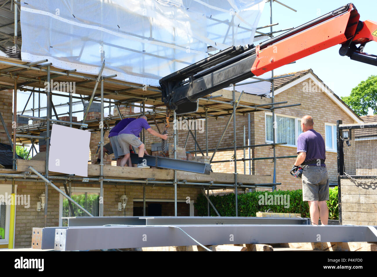 A crane lifting a girder into position Stock Photo - Alamy