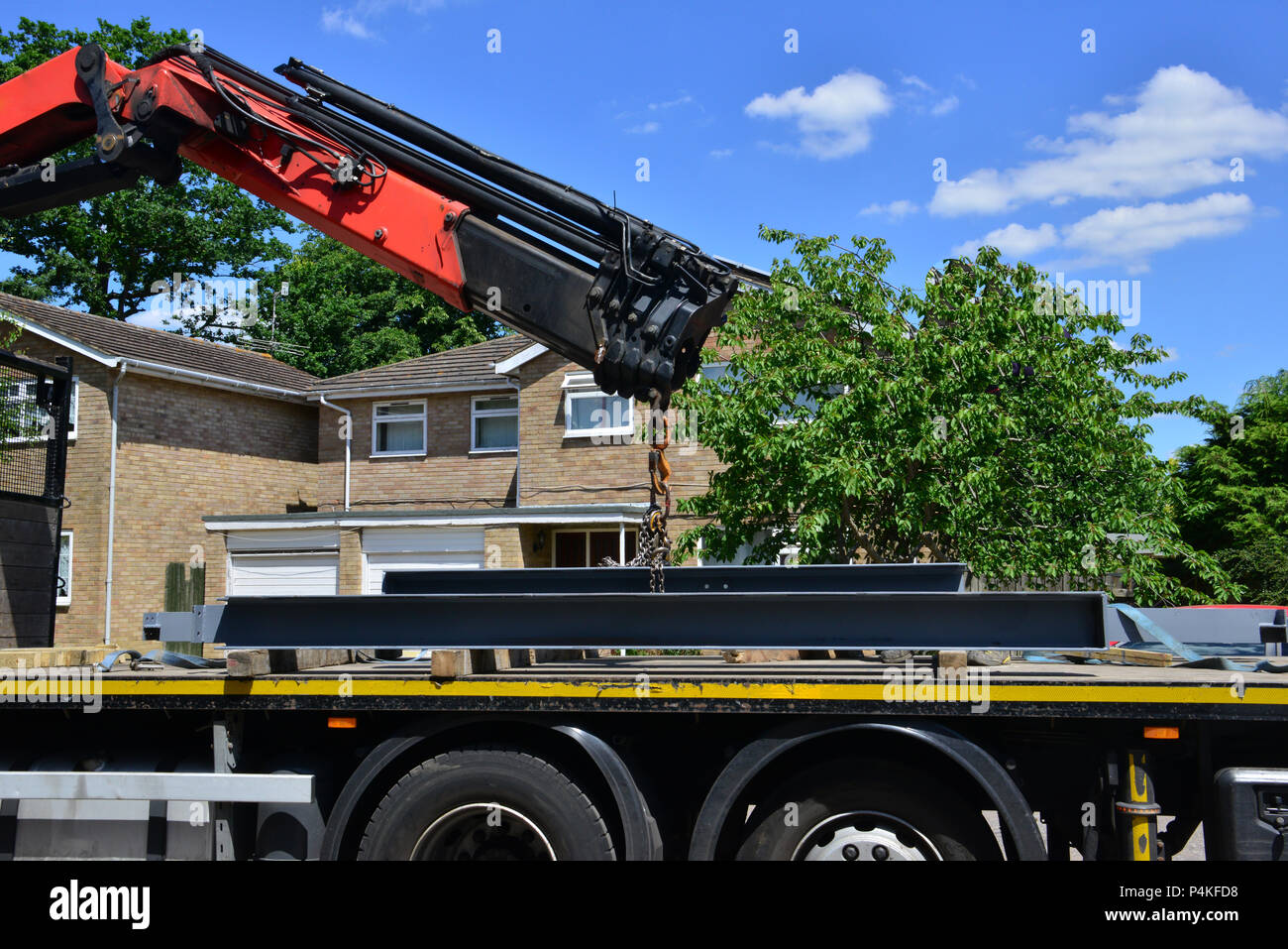 A crane lifting steel for an extension on a house in the UK Stock Photo ...