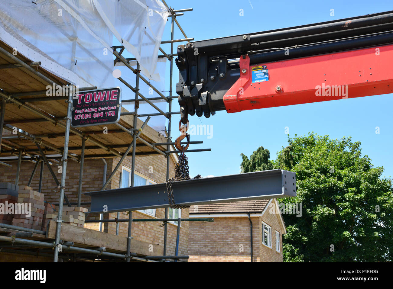 A crane lifting a girder into position Stock Photo - Alamy