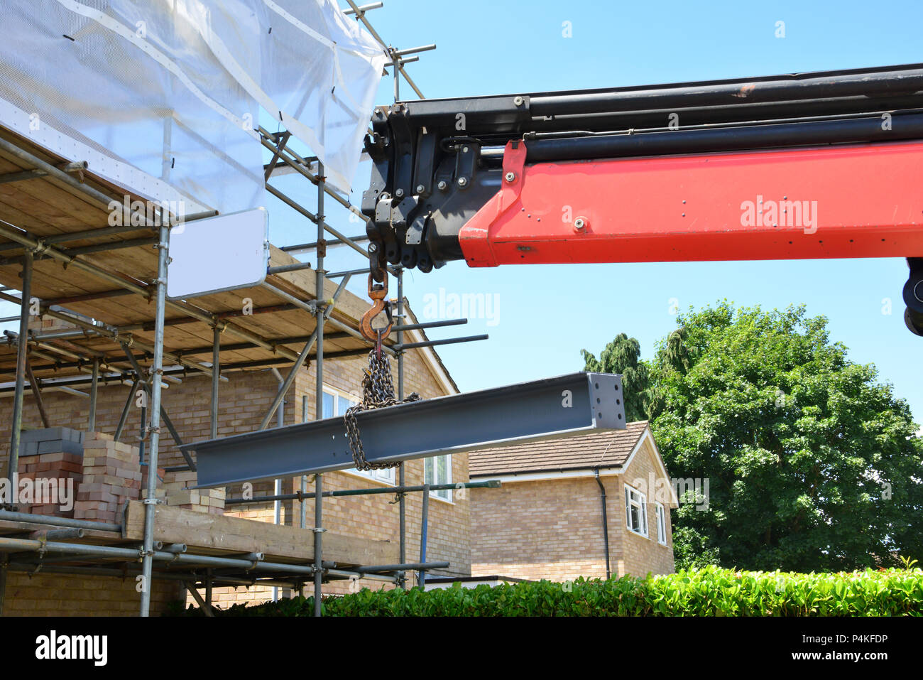 A crane lifting a girder into position Stock Photo - Alamy