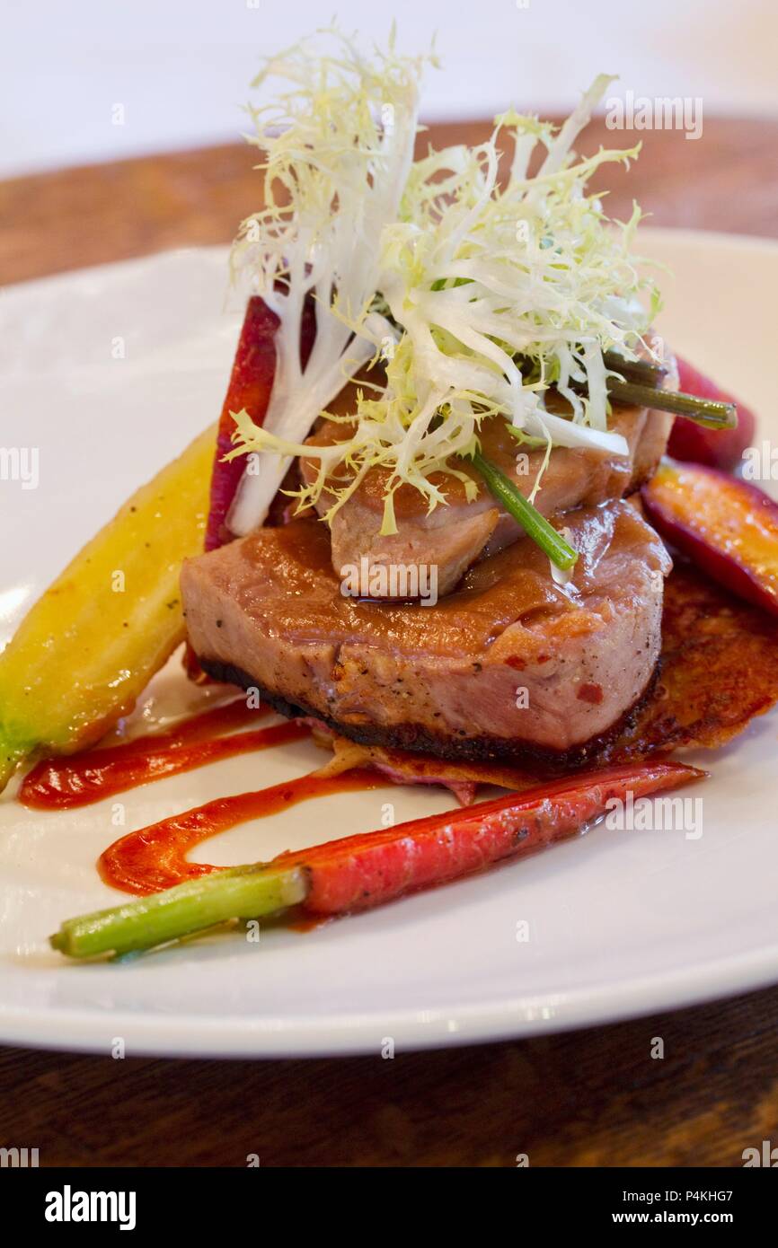 Fried pork medallions with carrots and dates Stock Photo - Alamy