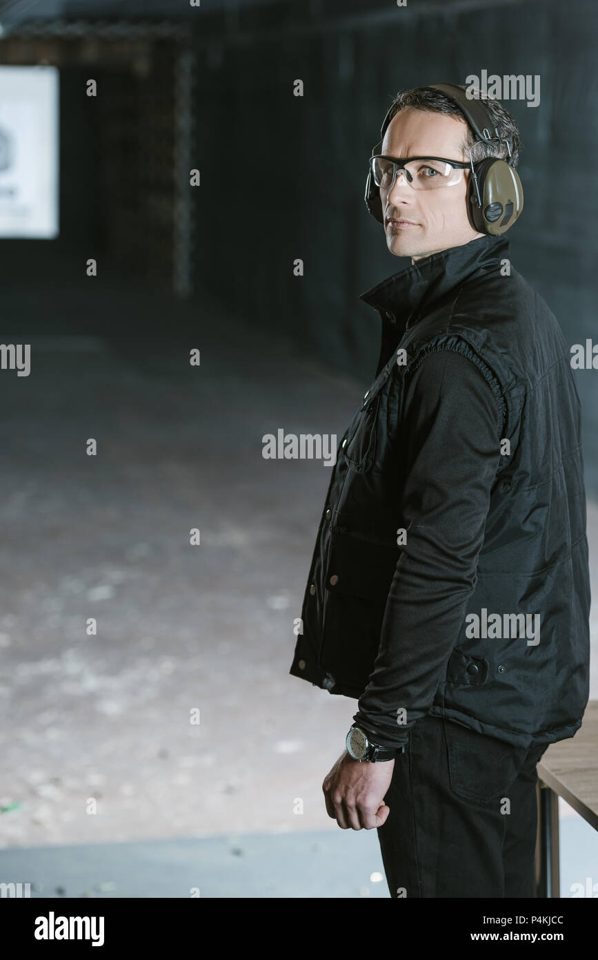 handsome man looking at camera in shooting range Stock Photo - Alamy
