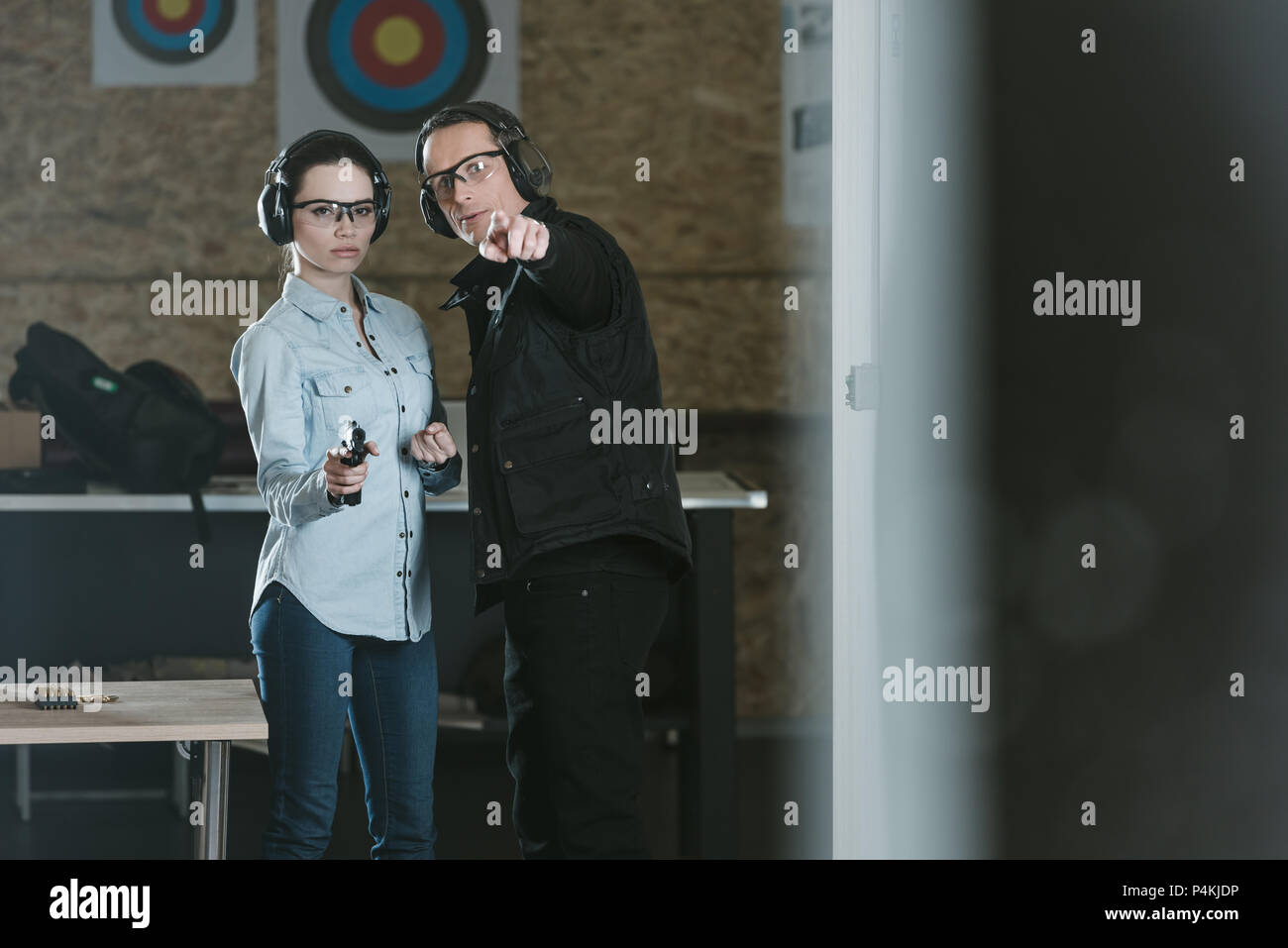 male instructor pointing on target in shooting range Stock Photo - Alamy