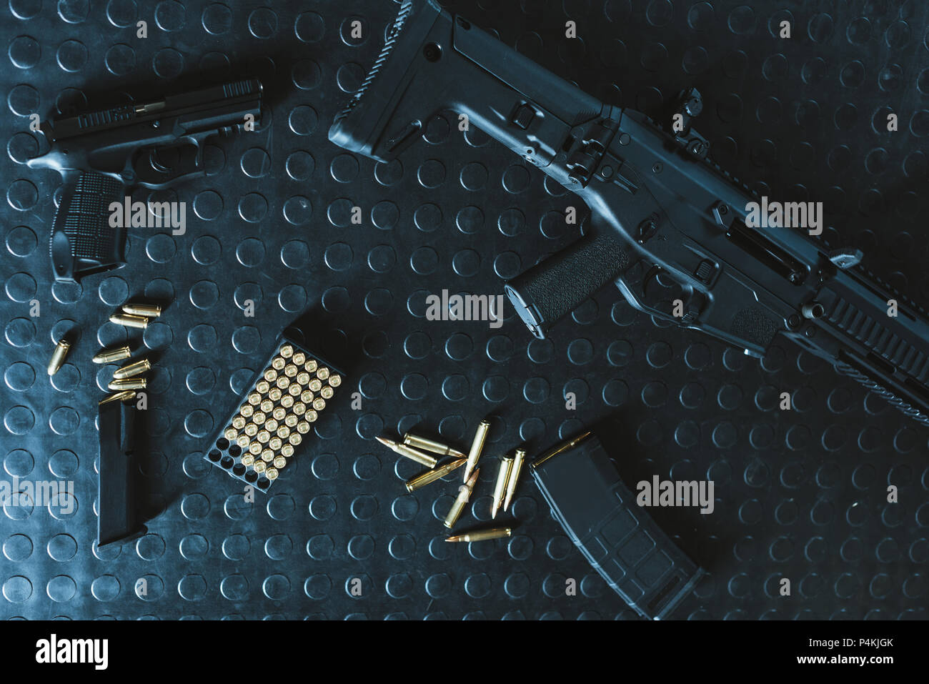 top view of gun and rifle with bullets on table Stock Photo - Alamy