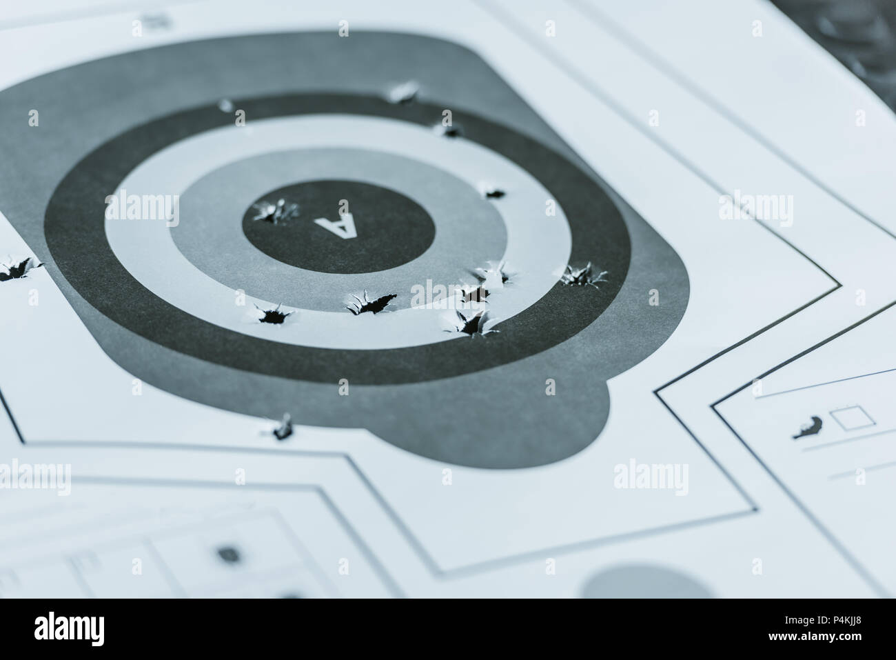 used gun target with holes after bullets in shooting range Stock Photo ...