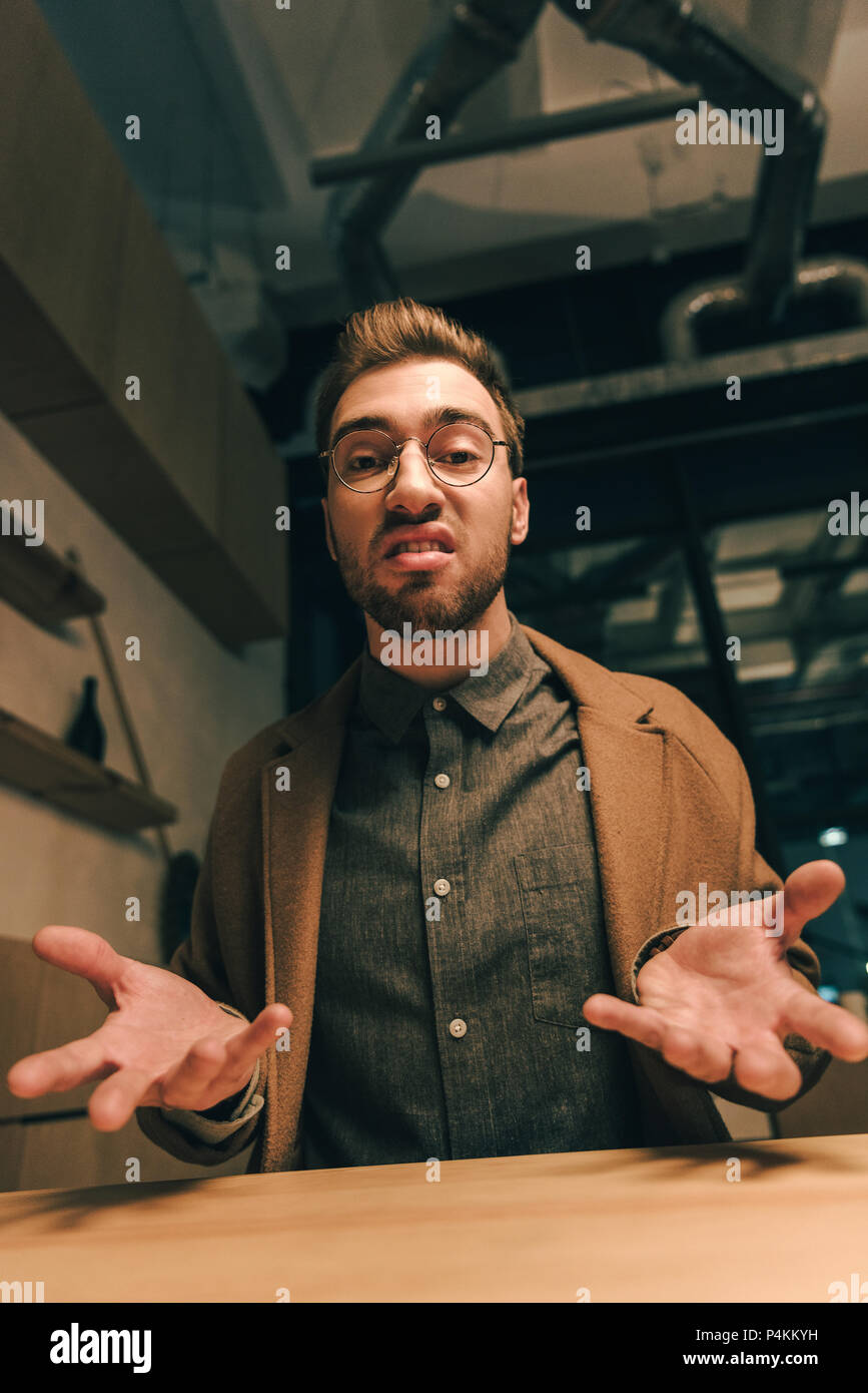 portrait of bully man gesturing and looking at camera in cafe Stock ...