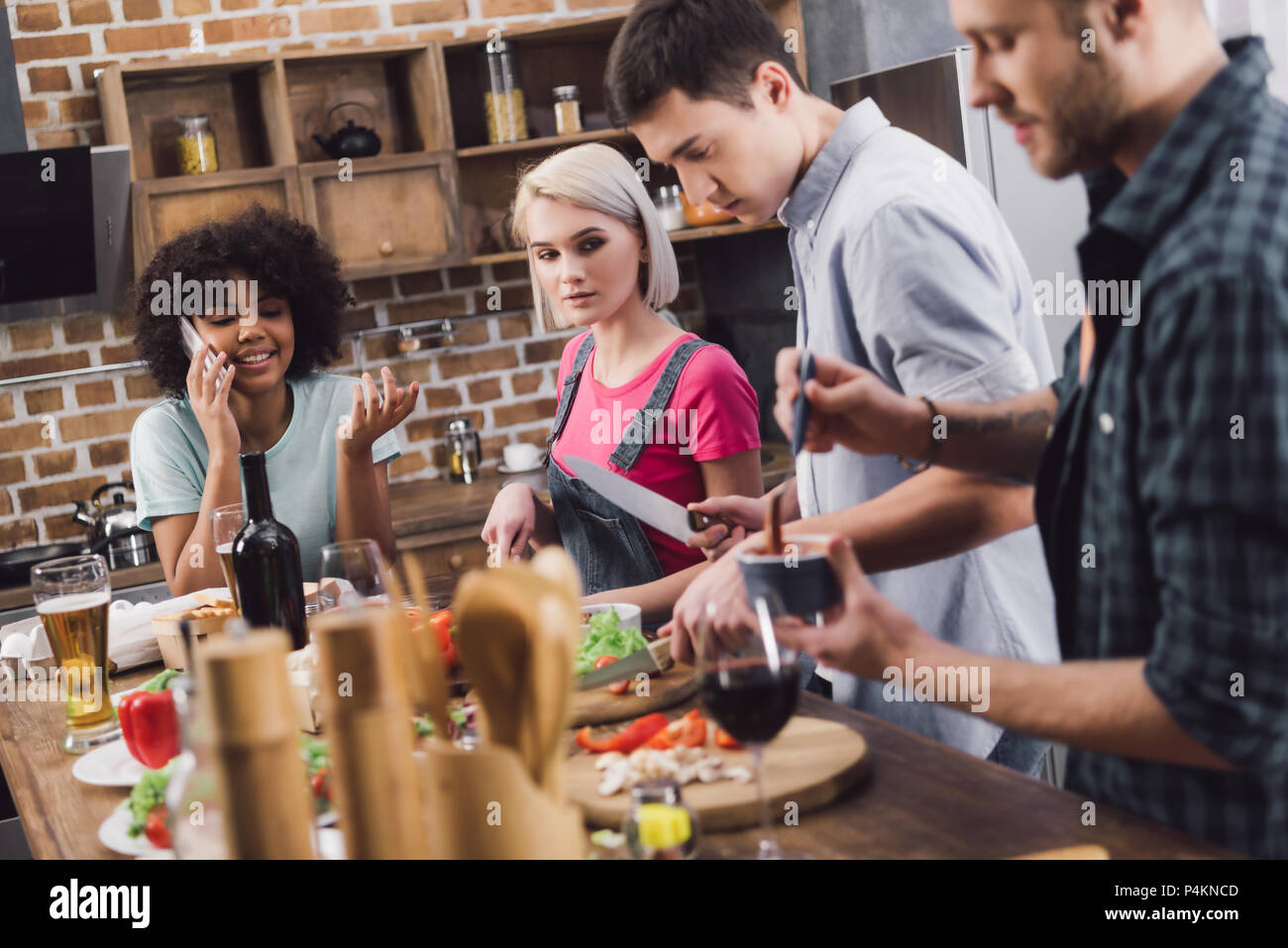 african american girl talking by smartphone while friends cooking Stock ...