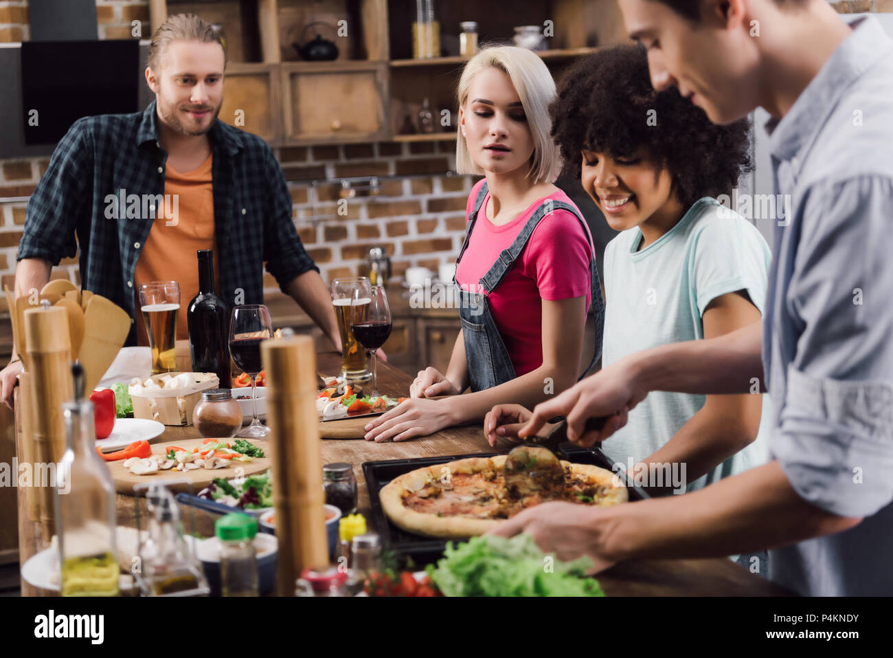 multicultural friends preparing pizza at home Stock Photo - Alamy