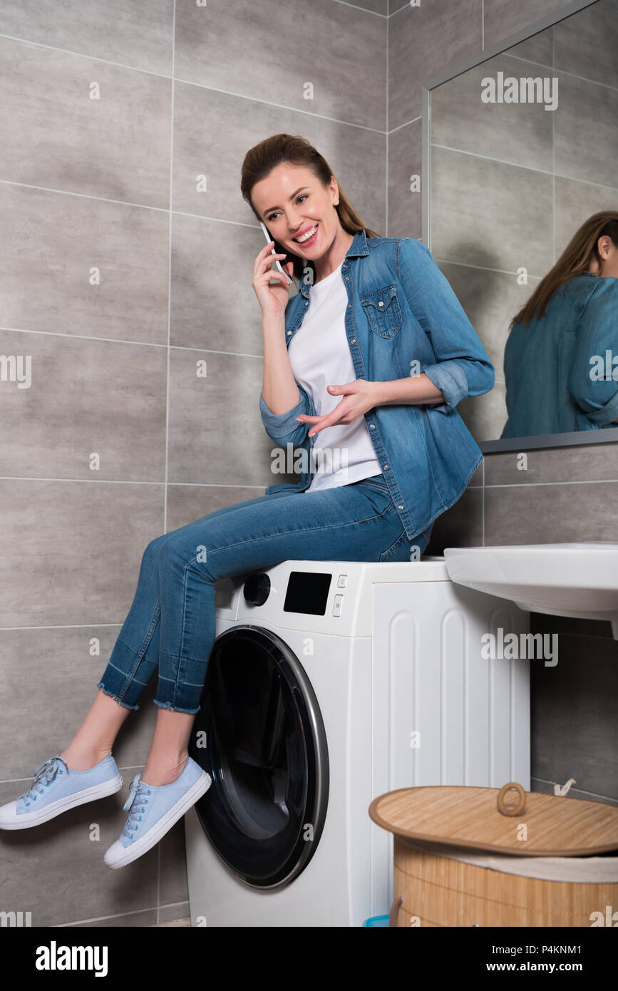 Girl sitting on washing machine hi-res stock photography and images - Alamy