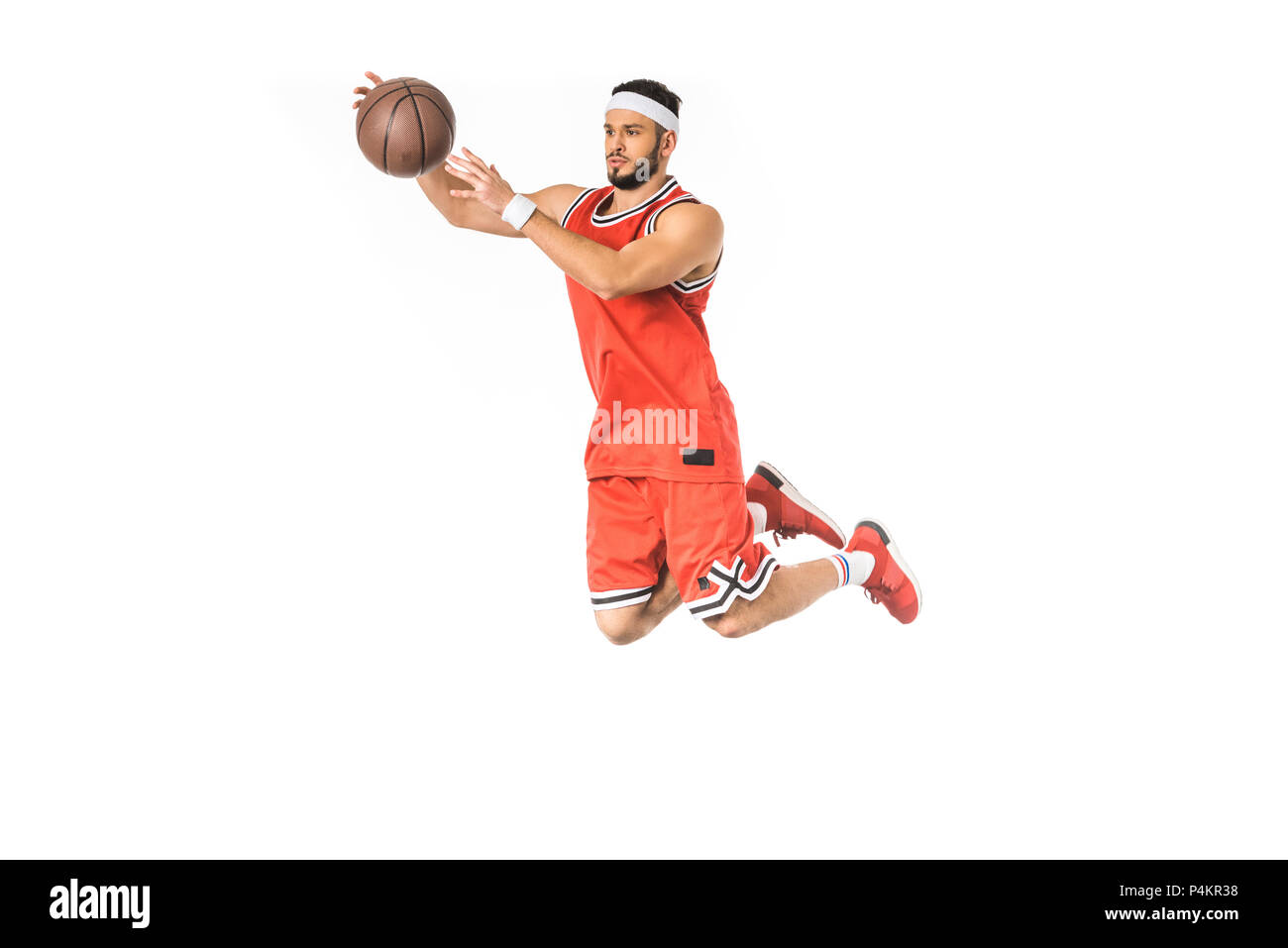 young basketball player catching ball in jump isolated on white Stock ...