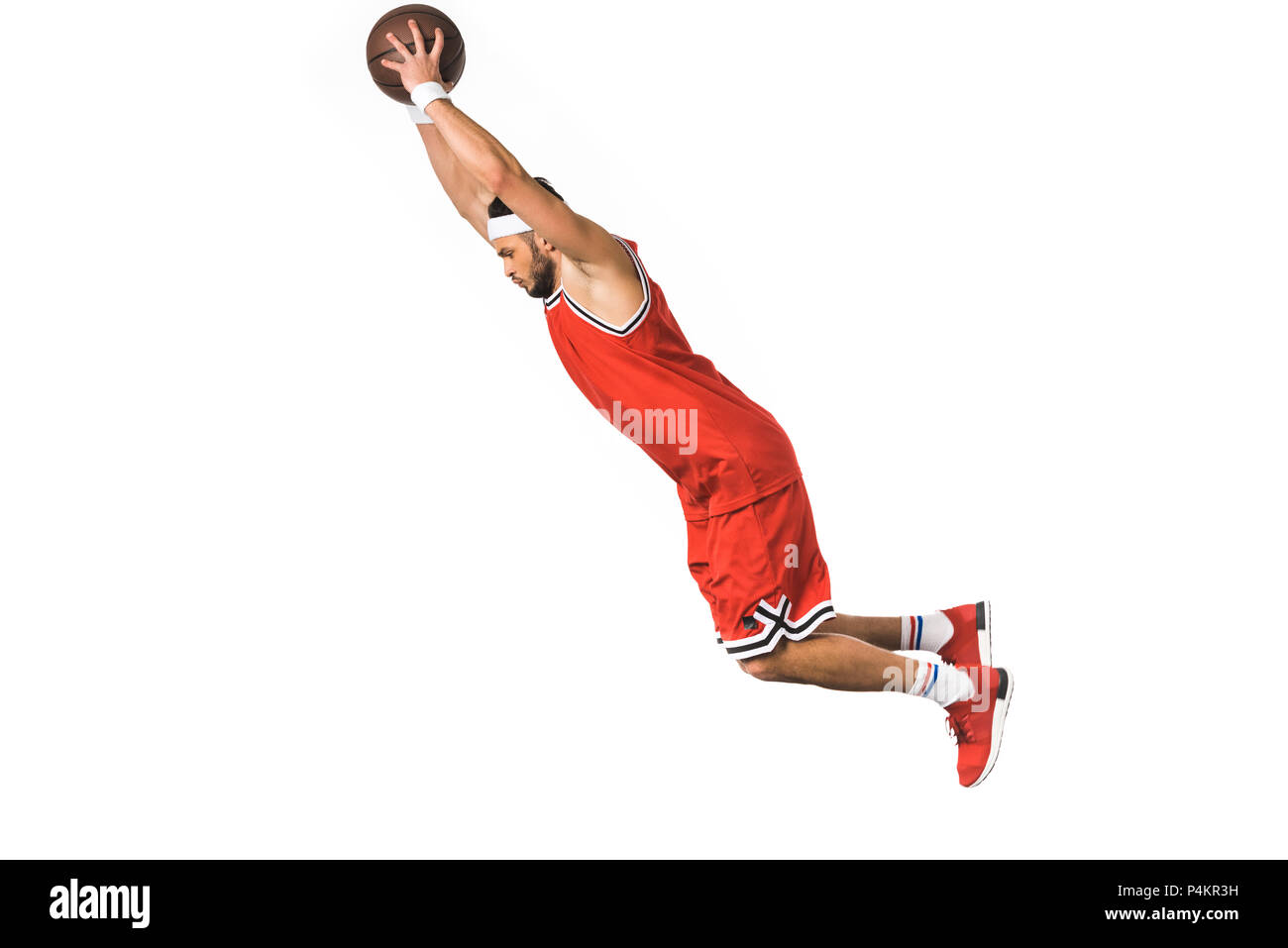 side view of young basketball player with ball jumping isolated on ...