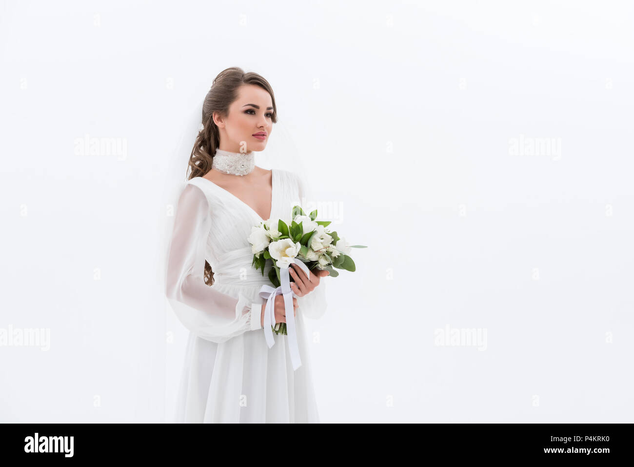 attractive bride in traditional dress holding wedding bouquet, isolated ...