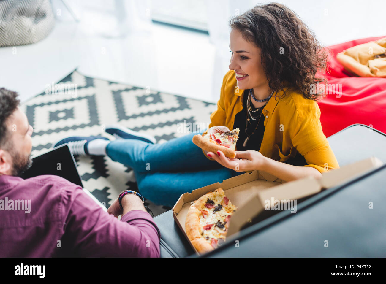 Man on couch eating pizza hi-res stock photography and images - Alamy