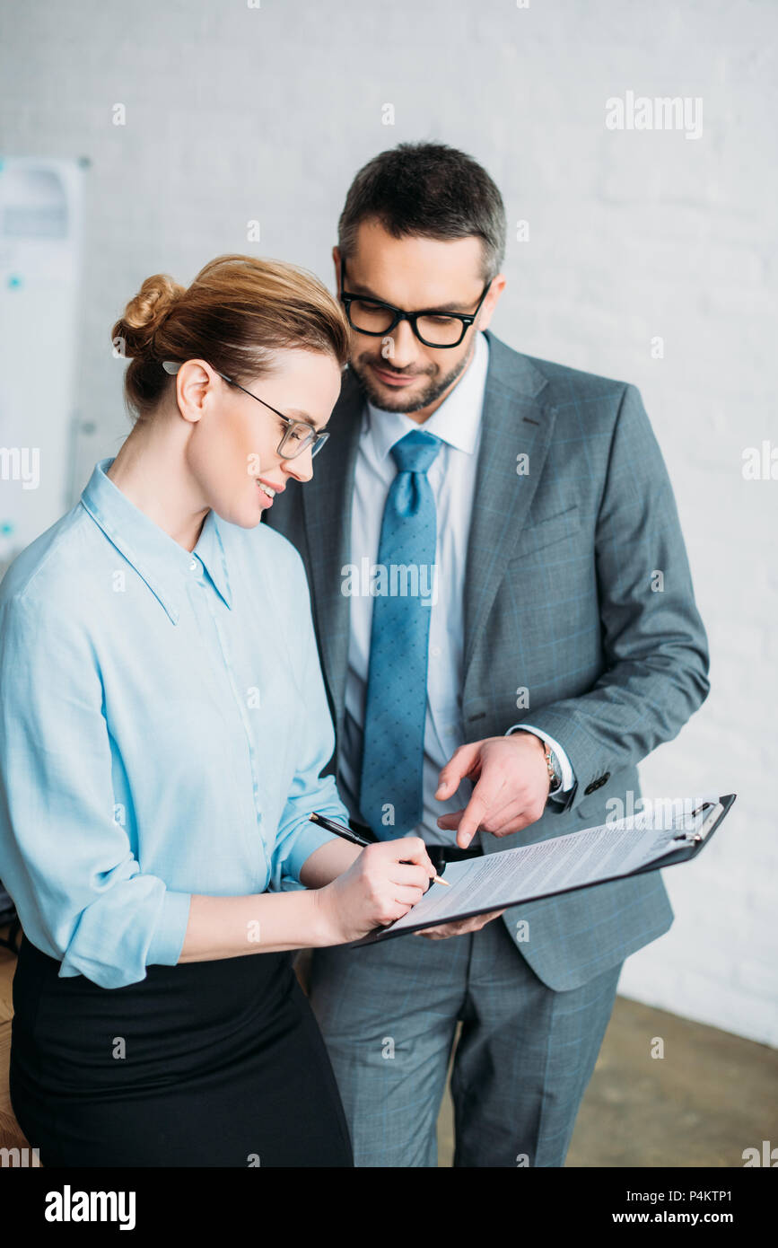 businessman pointing where to sign contract for colleague Stock Photo ...