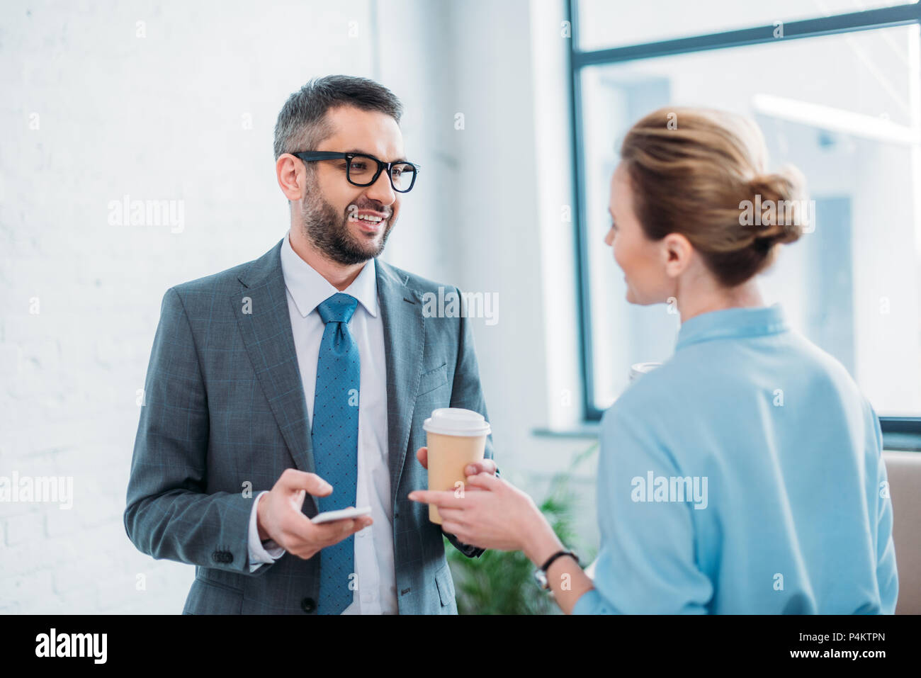 Talking professionals in suits hi-res stock photography and images - Alamy