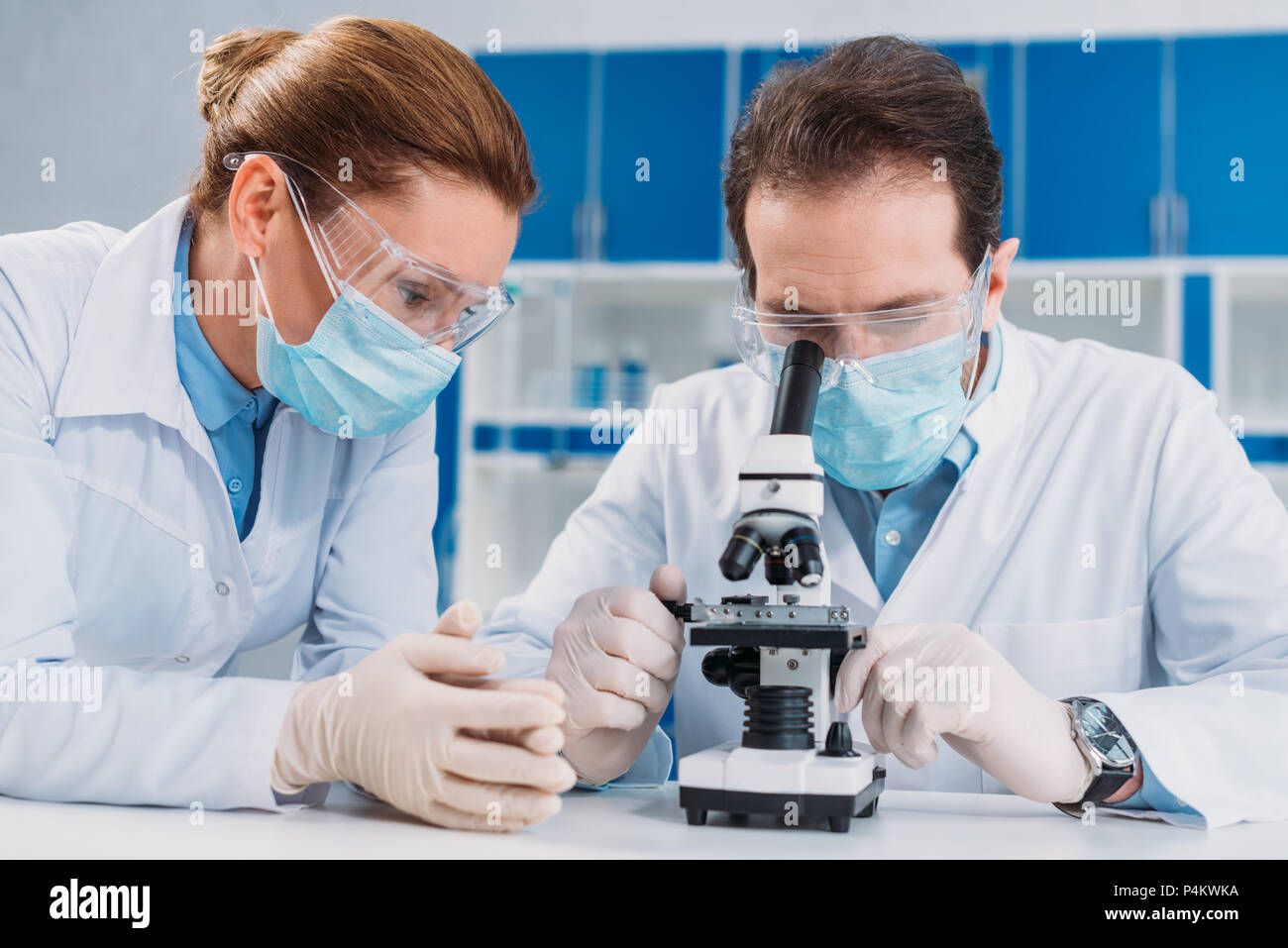 portrait of researchers in medical masks and gloves working with ...