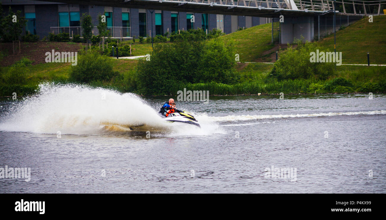 A man and a boy on a Jet Ski on the River Tees at Stockton on Tees ...