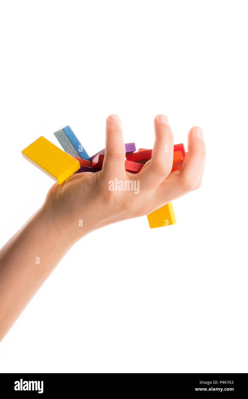 Falling colorful domino onto a hand Stock Photo - Alamy