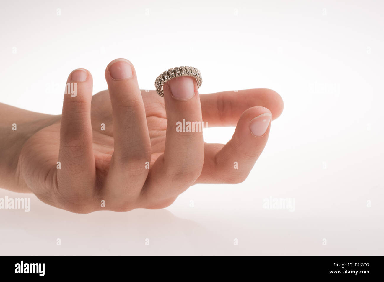 Hand wearing a ring on a white background Stock Photo - Alamy