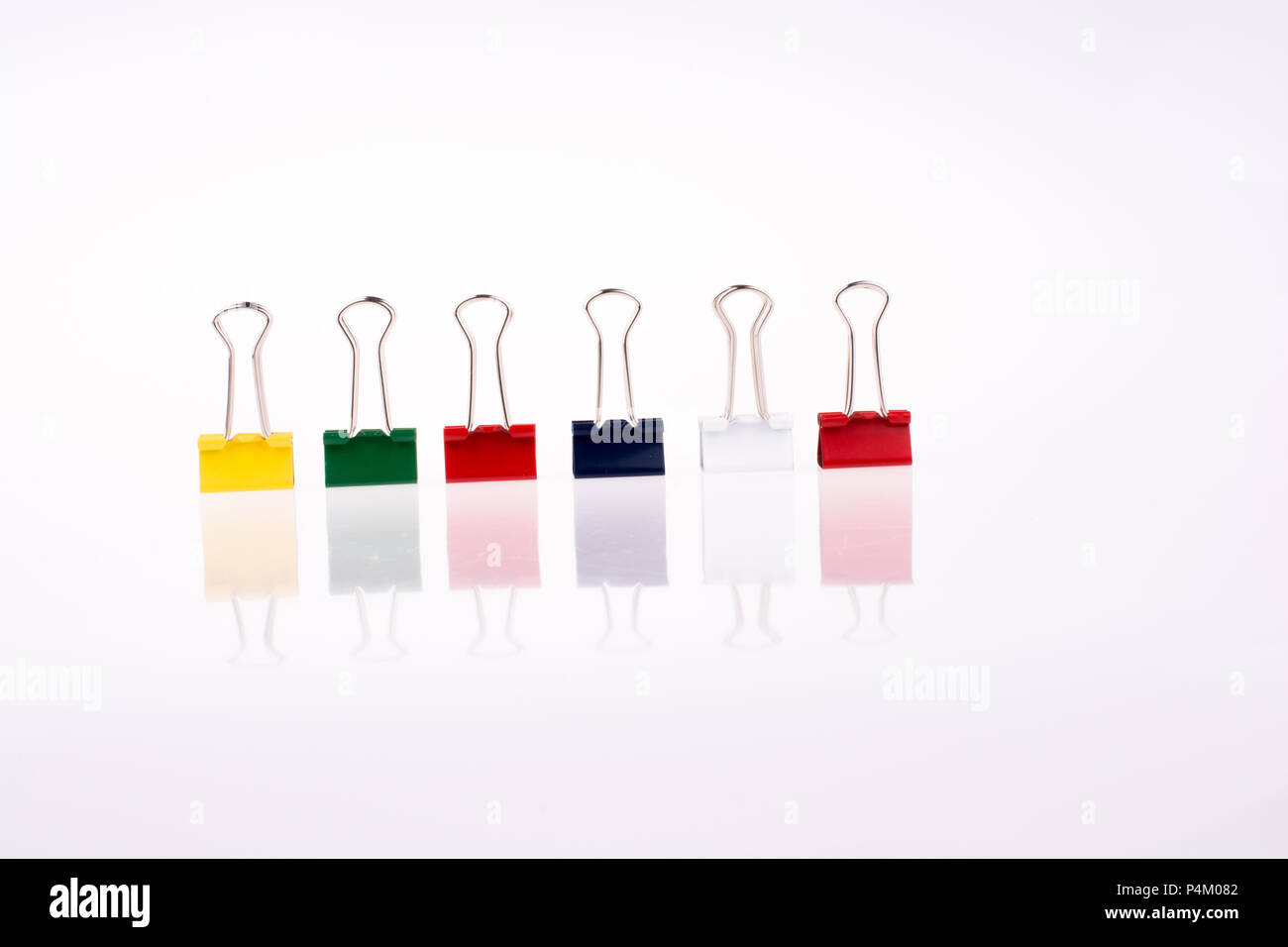 Colored paper clips on a white background Stock Photo - Alamy