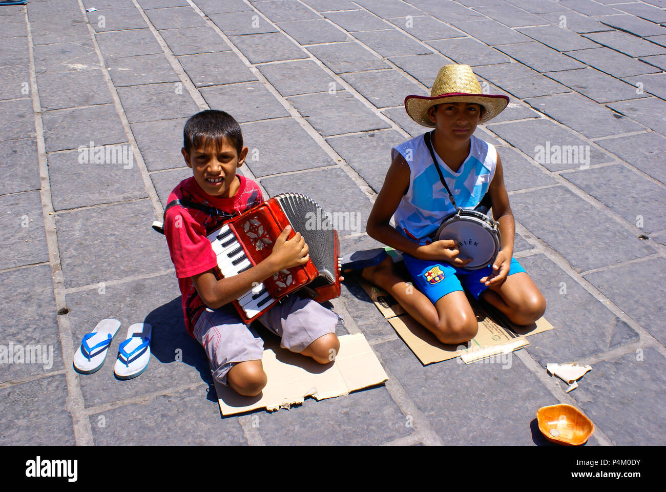 Chania, Greece, 22 July 2009. Two gypsy boys play music Stock Photo - Alamy