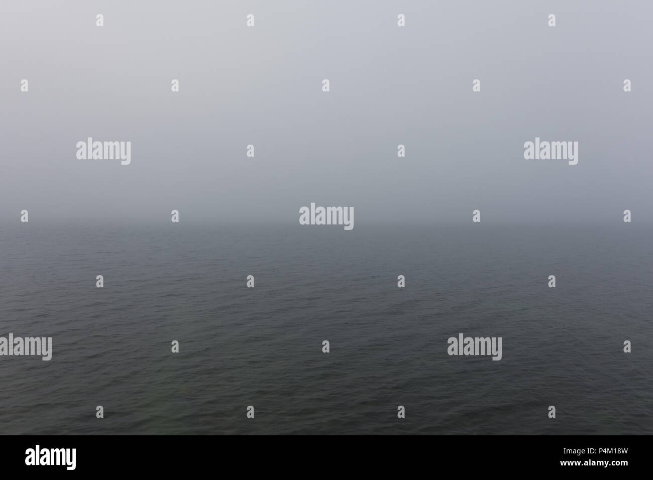 Morning calm water surface with heavy fog Stock Photo - Alamy