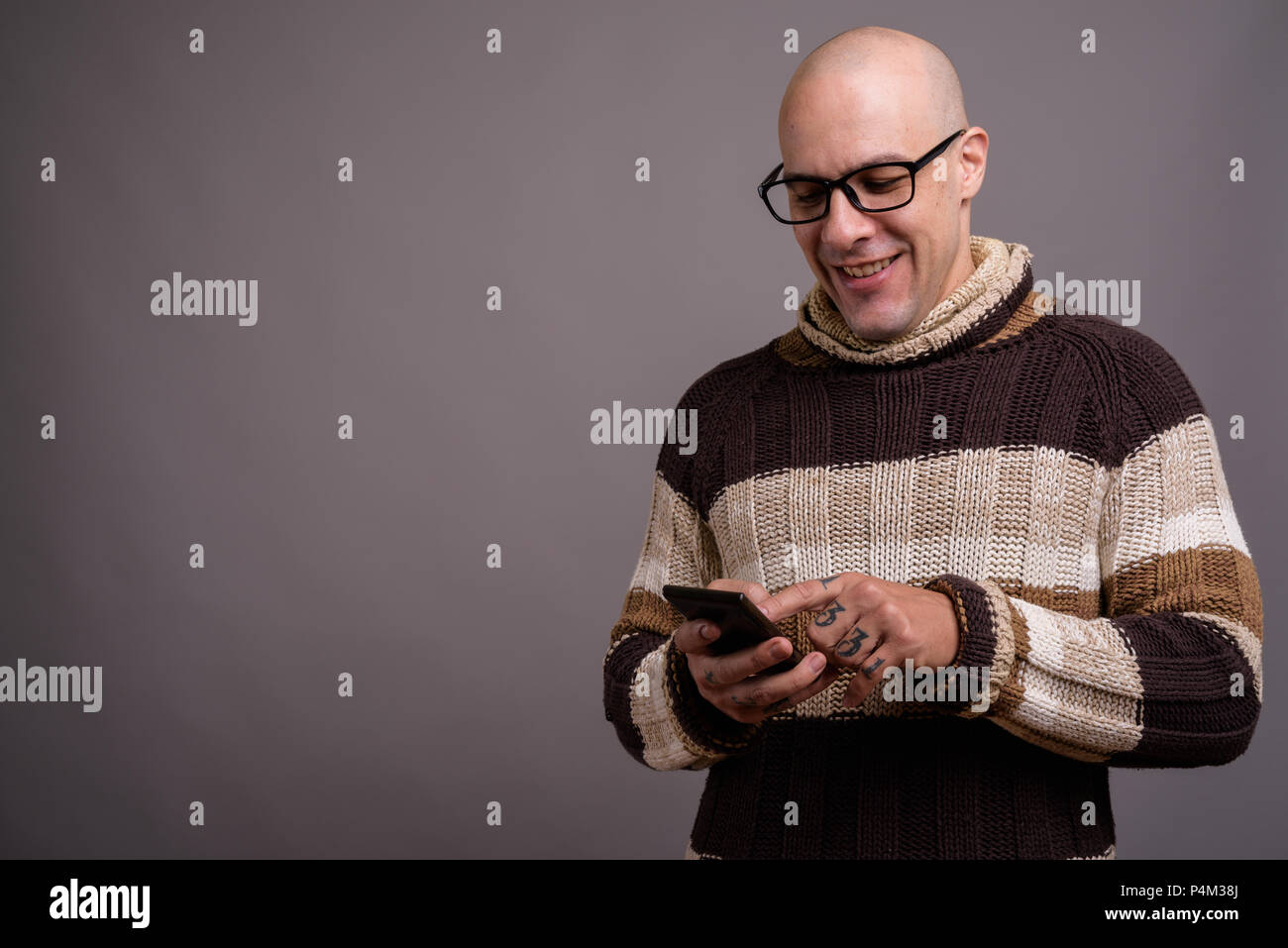 Handsome bald man against gray background Stock Photo - Alamy