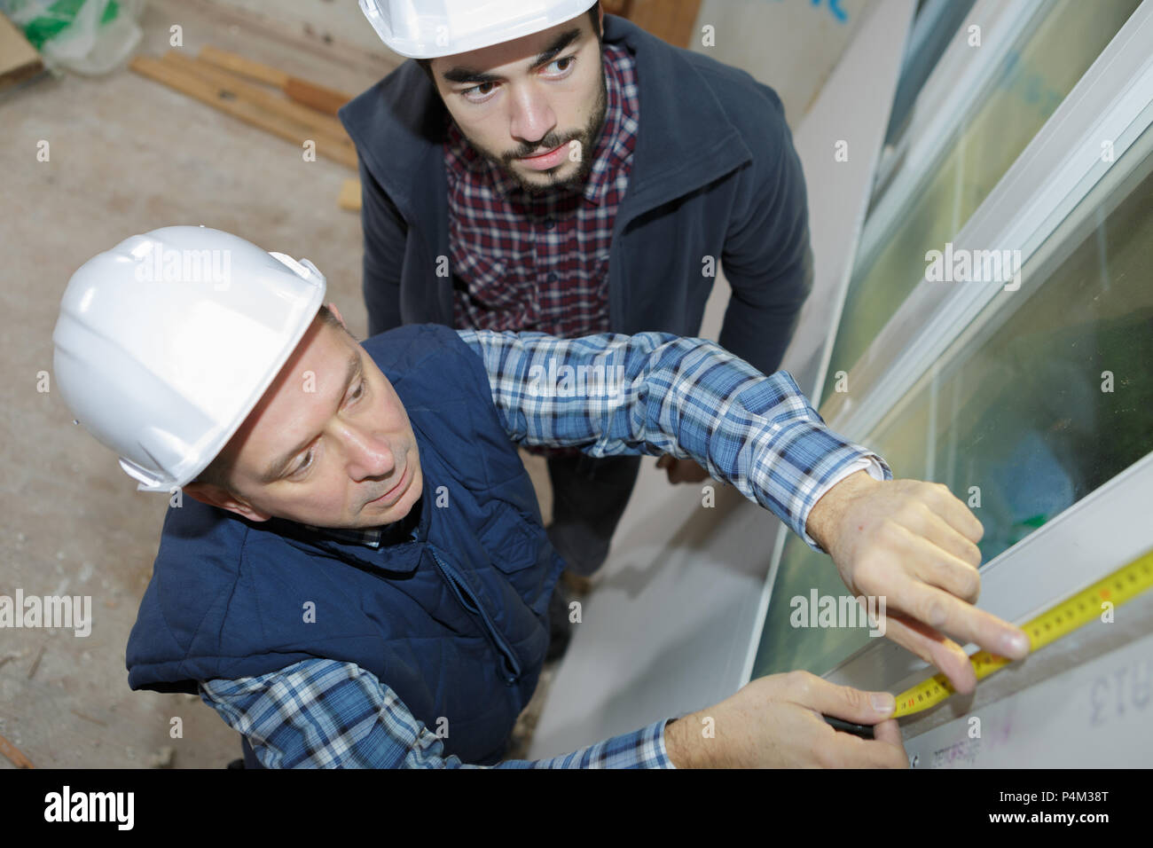 builder measuring windows Stock Photo - Alamy