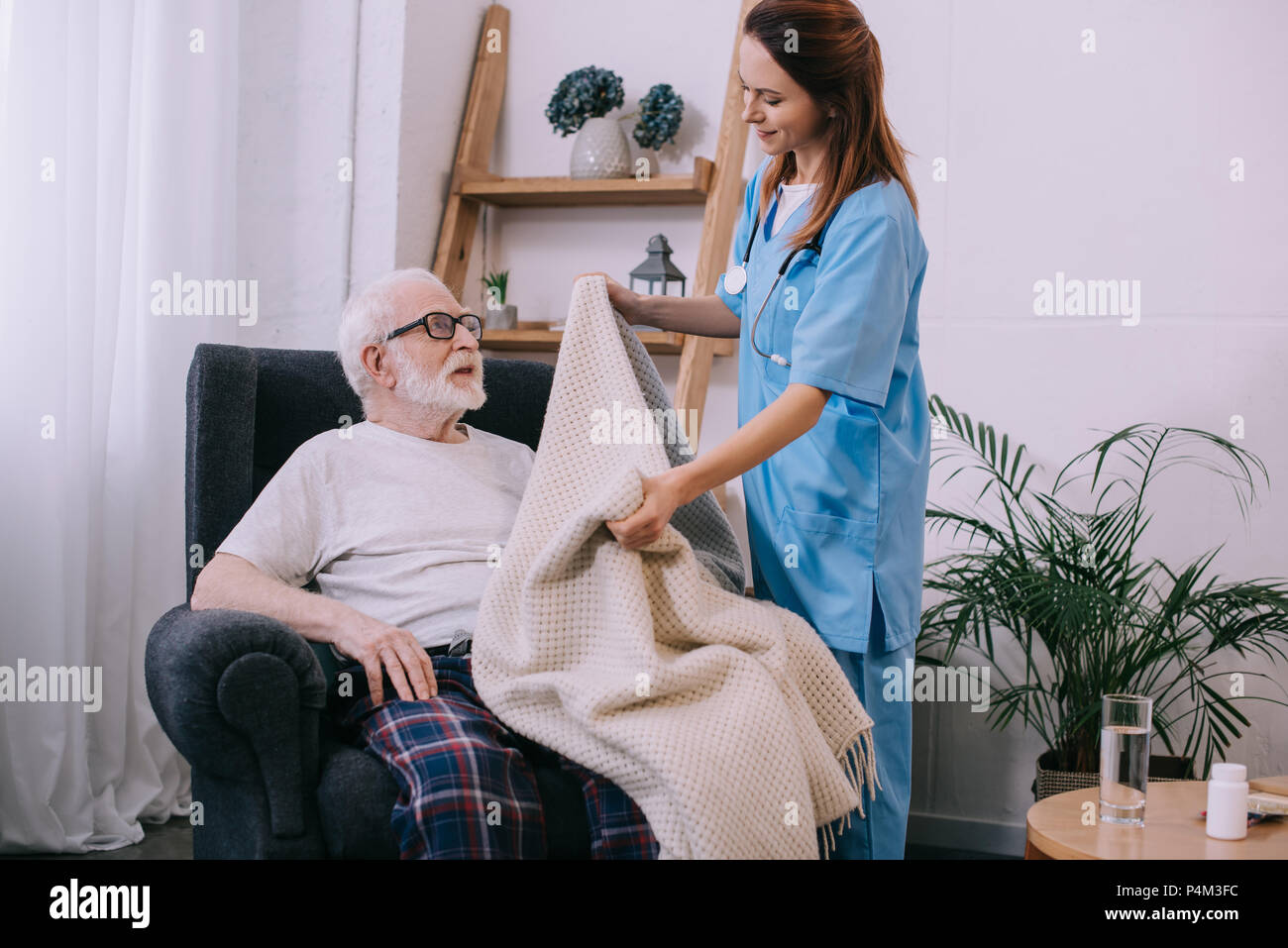 Female caregiver covering senior hi-res stock photography and images ...