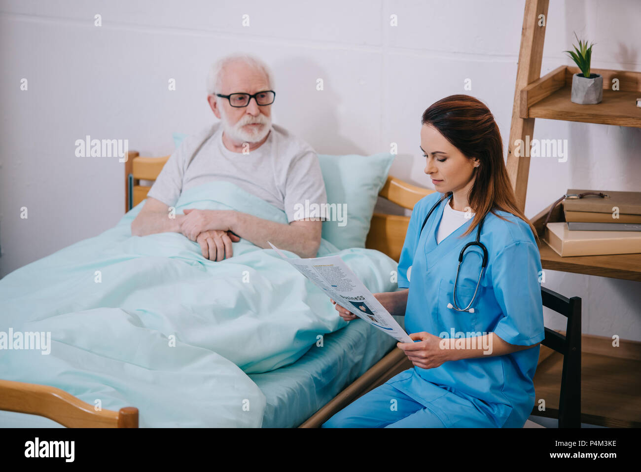 Hospital patient reading newspaper hi-res stock photography and images ...