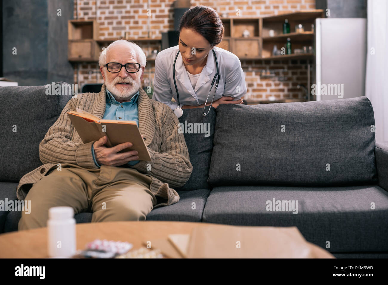 Doctor reading book hi-res stock photography and images - Alamy