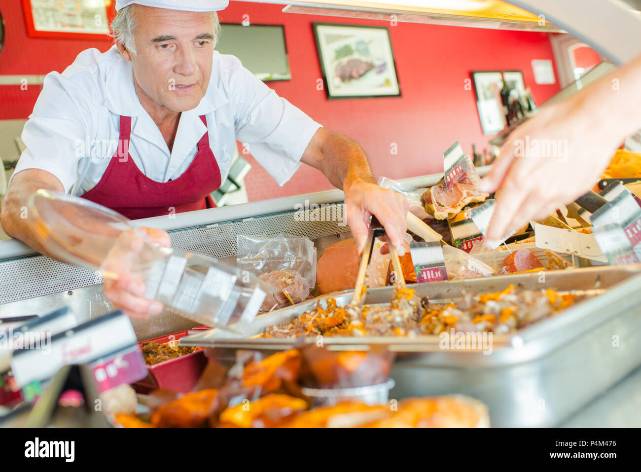 butcher serving customer Stock Photo - Alamy