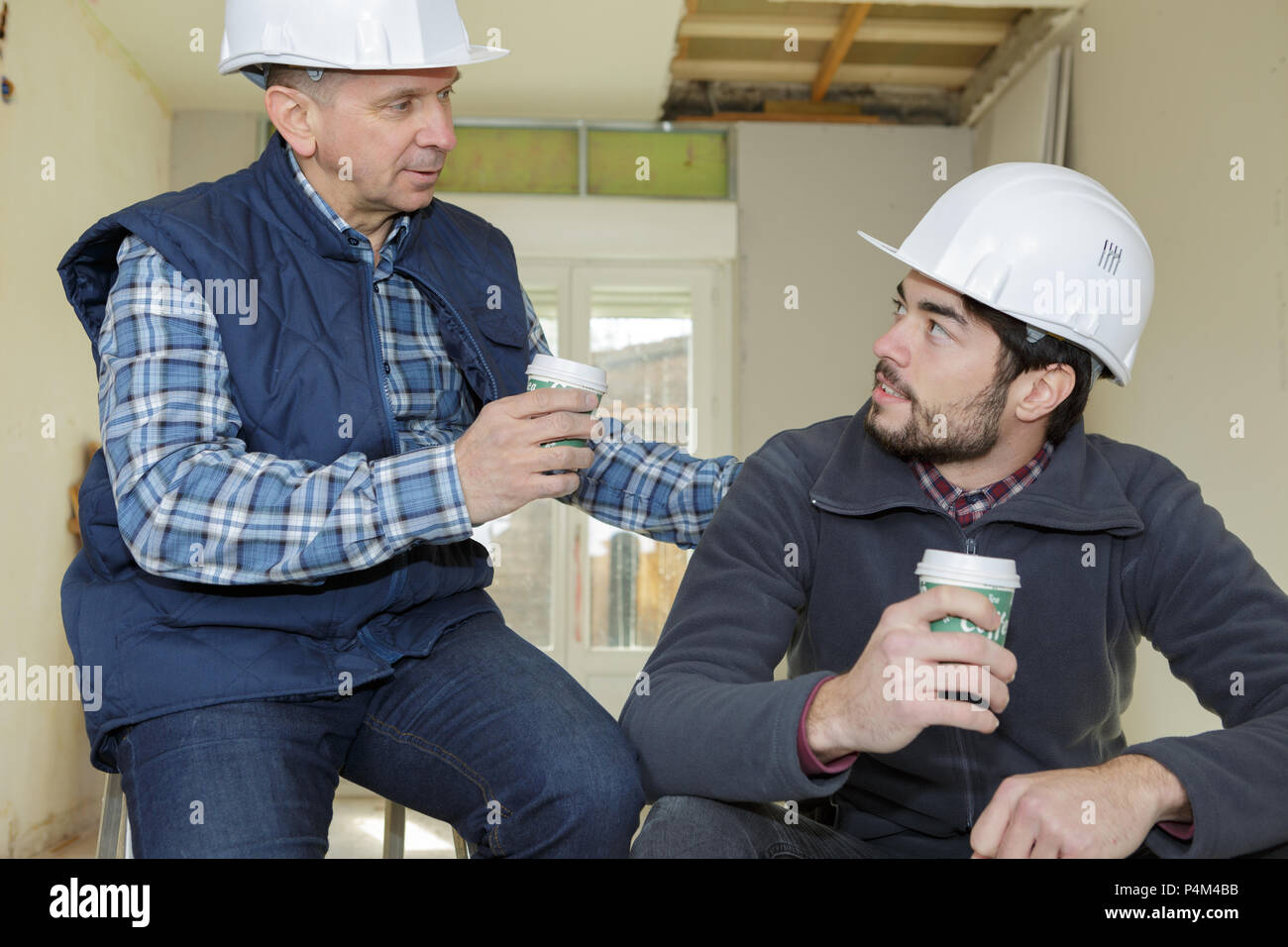 happy construction workers holding disposable coffee cups Stock Photo ... happy construction workers holding disposable coffee cups Stock Photo ...
