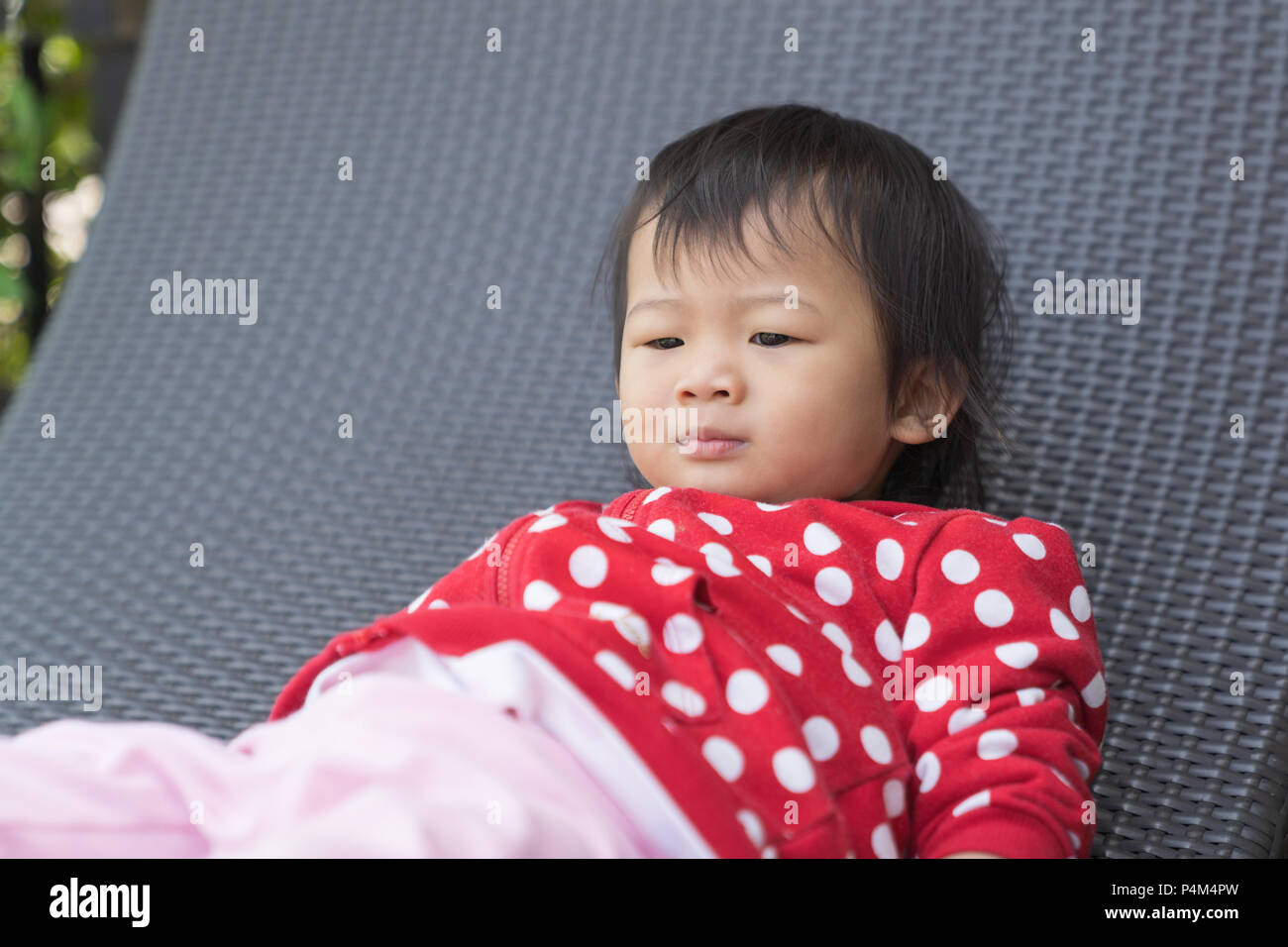 Asian cute girl kid is boring on modern sofa, baby kids concept in ...