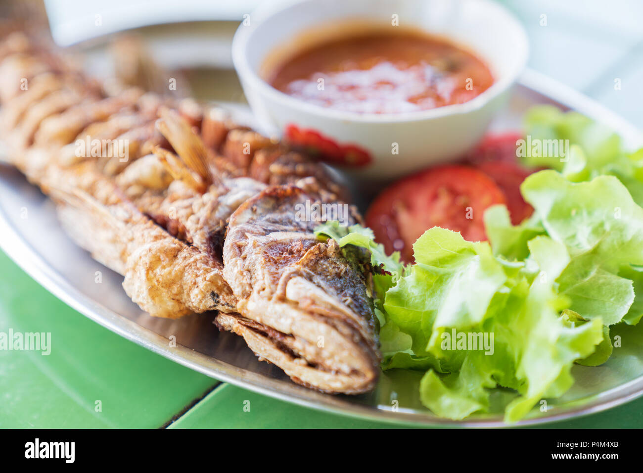 Fried fresh big fish with salad and hot spicy sauce, thai food style ...