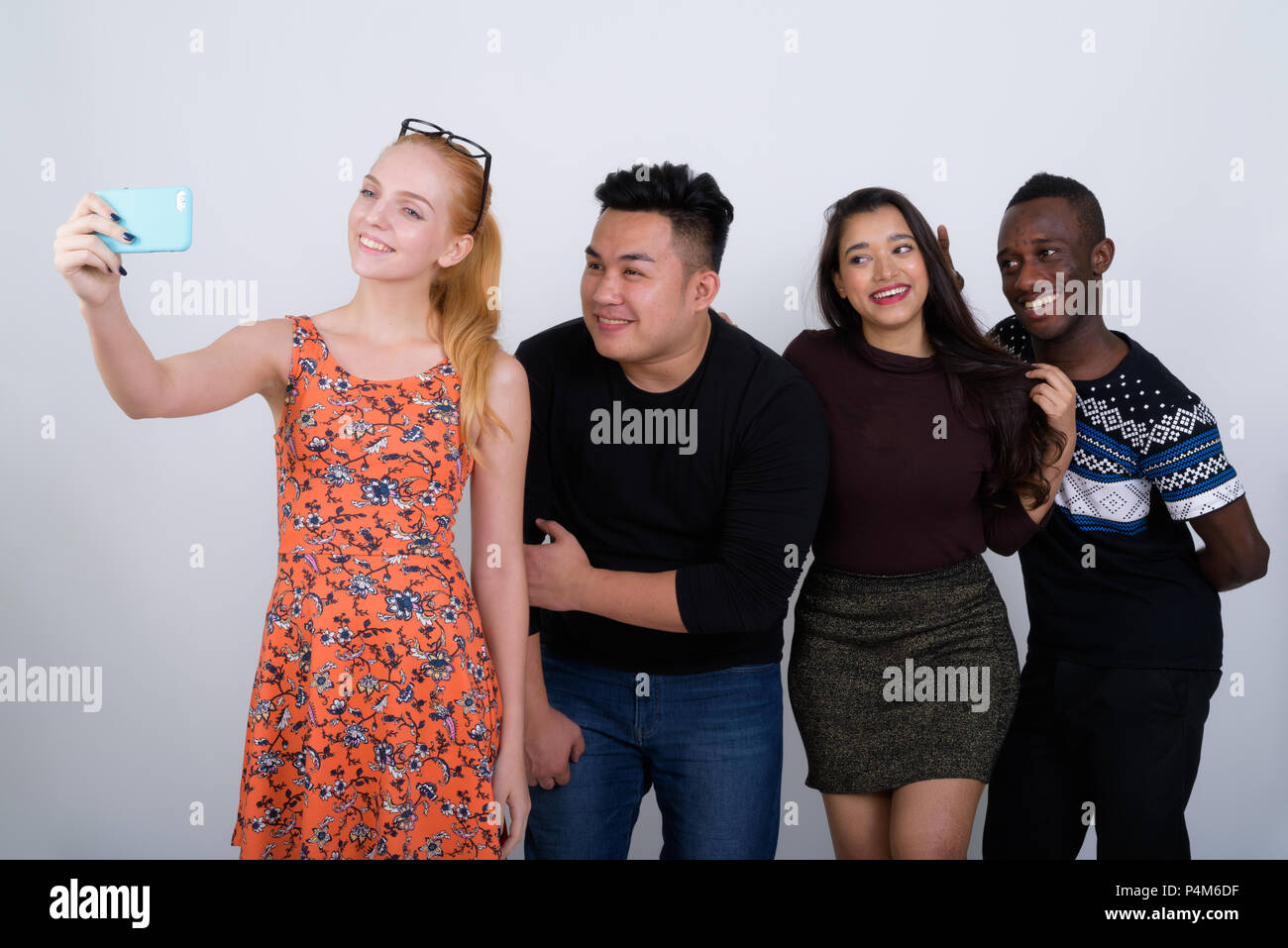 Happy diverse group of multi ethnic friends smiling while taking Stock ...