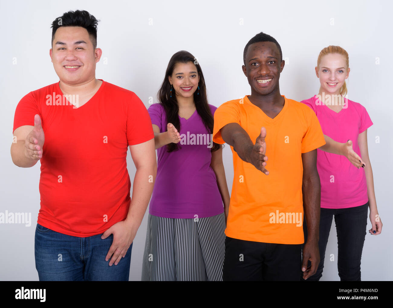 Happy multi ethnic friends greeting hi-res stock photography and images ...