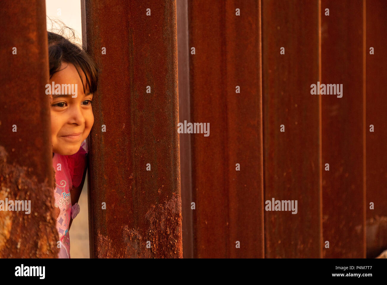Children play on the Mexican side of the US Mexican border wall, Trump ...