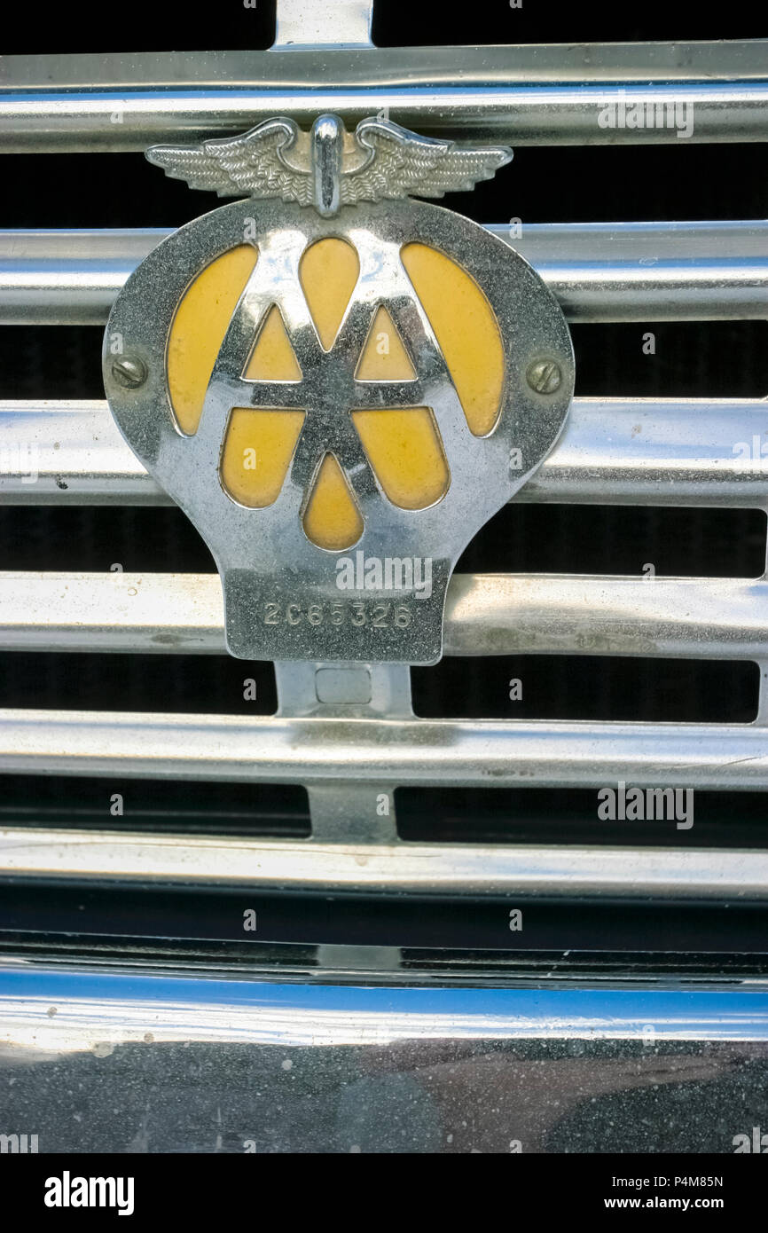 Old AA Automobile Association badge on the grille of a classic car ...