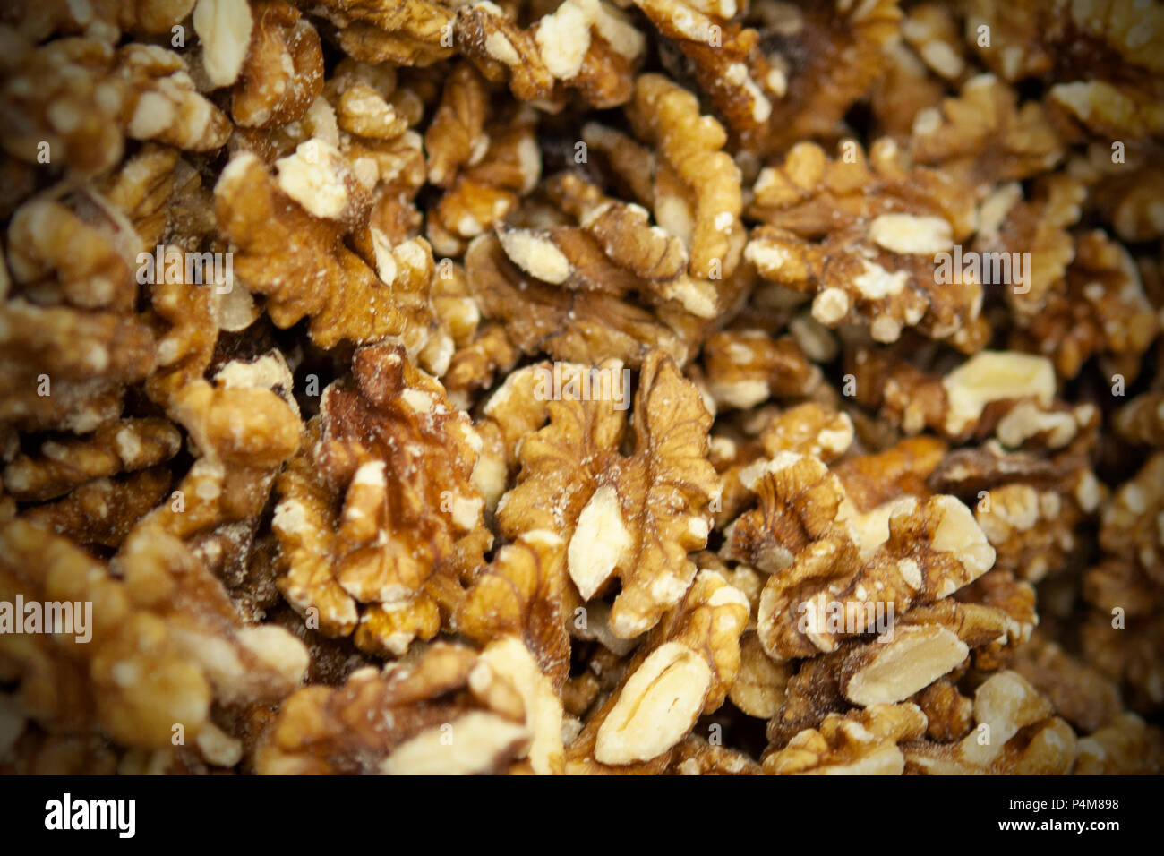 Closeup of a large shelled heap of walnuts, food background. View from ...