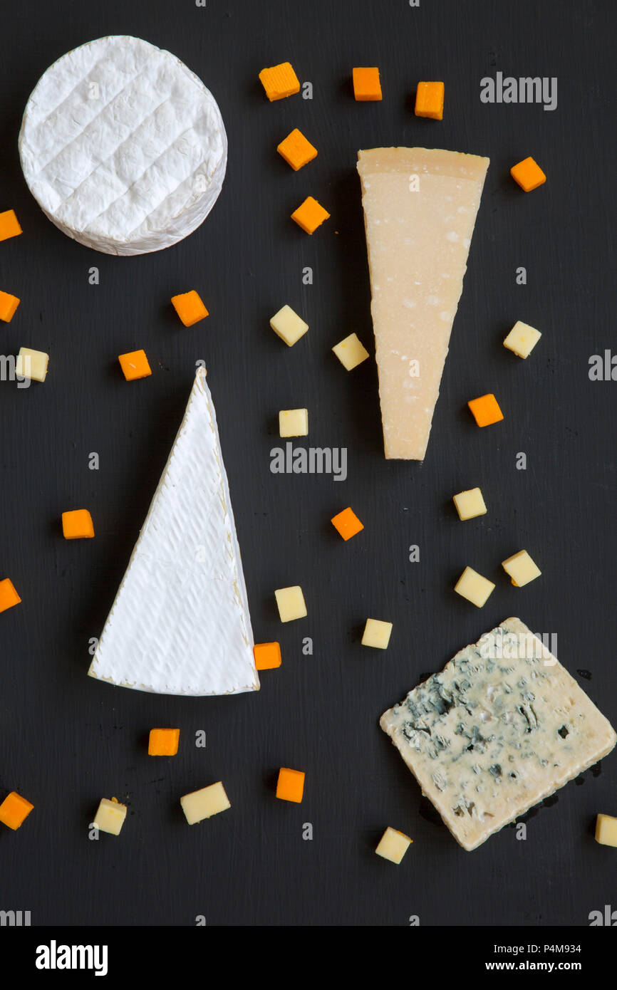 Collection of different types of cheese on dark background. Food for ...