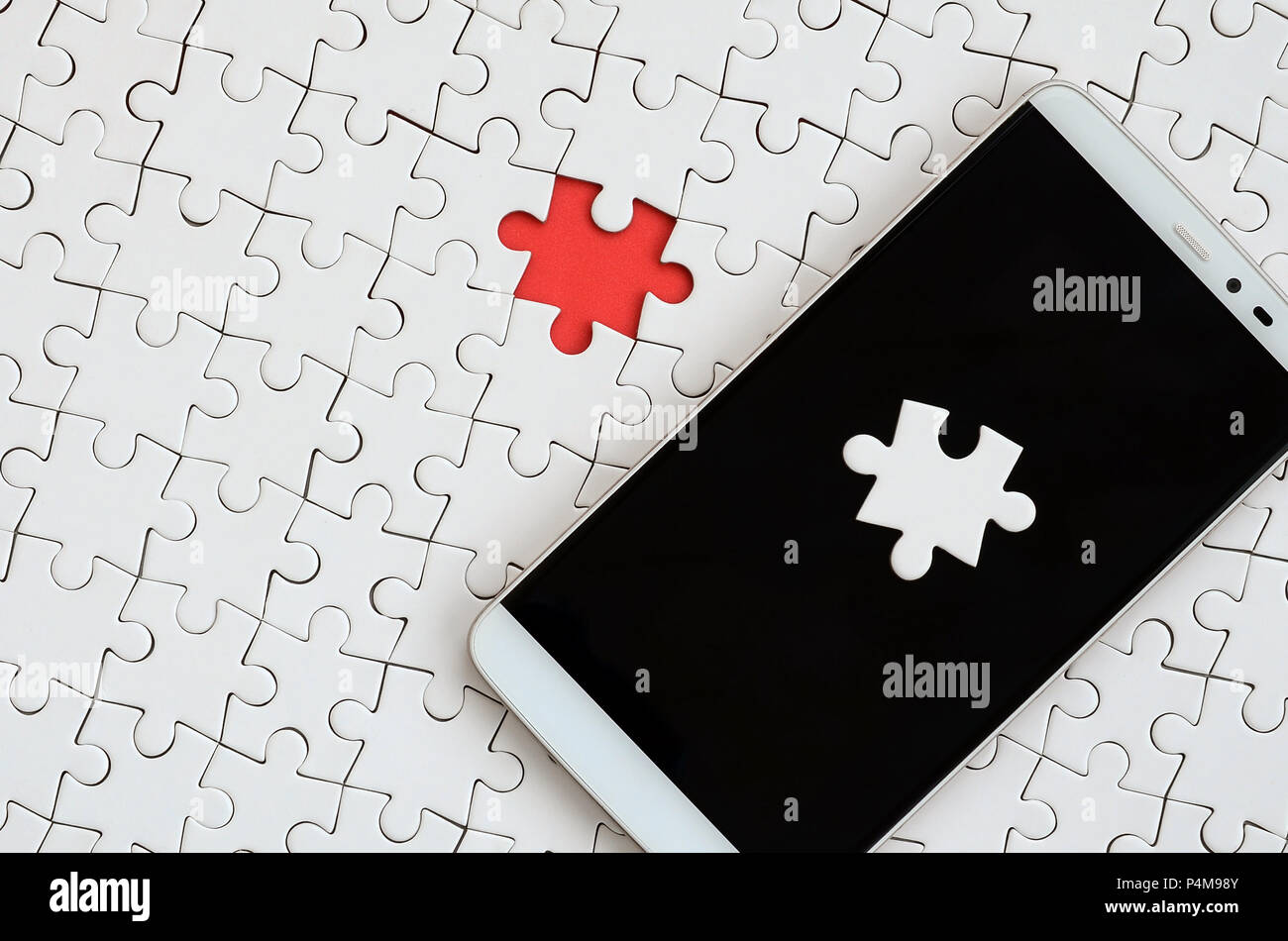 A modern big smartphone with several puzzle elements on the touch ...