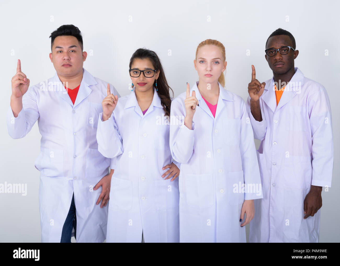Studio shot of diverse group of multi ethnic doctors pointing fi Stock ...