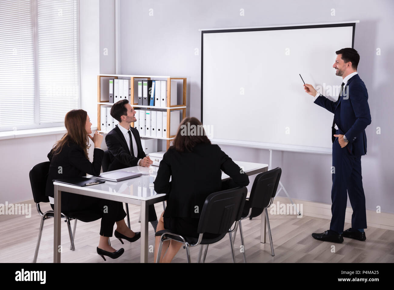 Young Businessman Giving Presentation To His Colleague In Meeting Stock ...